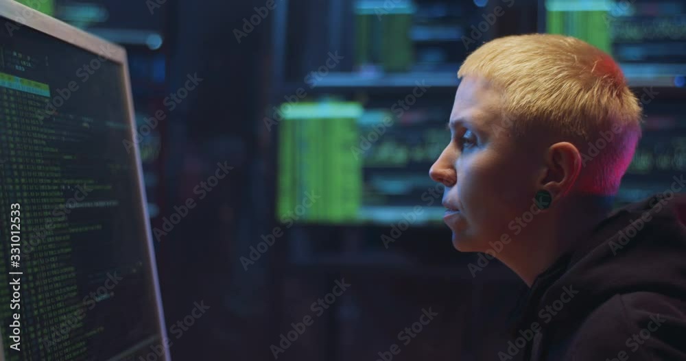 Wideo Stock: Side view on Caucasian woman hacker with blond short hair ...