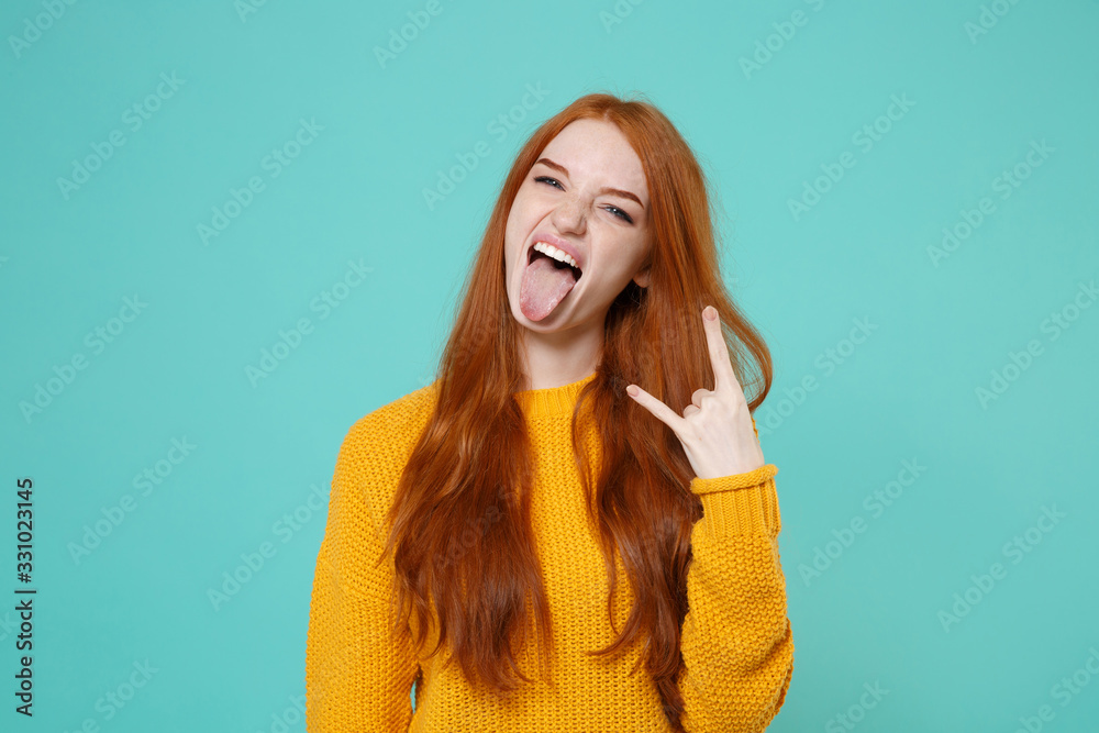 Crazy young redhead woman girl in yellow sweater isolated on blue ...