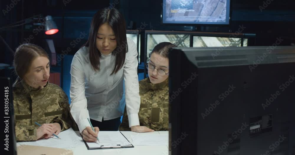 Two young Caucasian girls in uniforms of soldiers studying in military ...