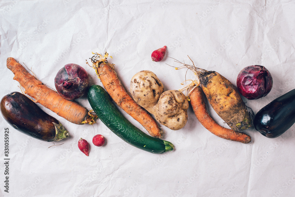 Ugly organic rotten vegetables with mutations on craft paper background ...