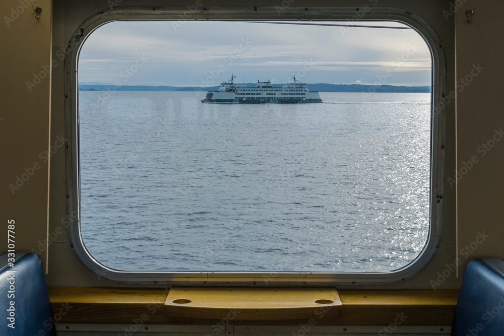 View across water from a ferry boat window, a ferry in Puget Sound ...