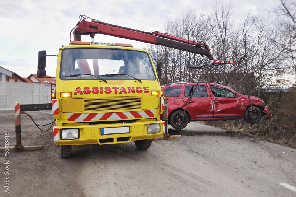 Assistance car lifts and loads a car after an accident. Tow truck with ...