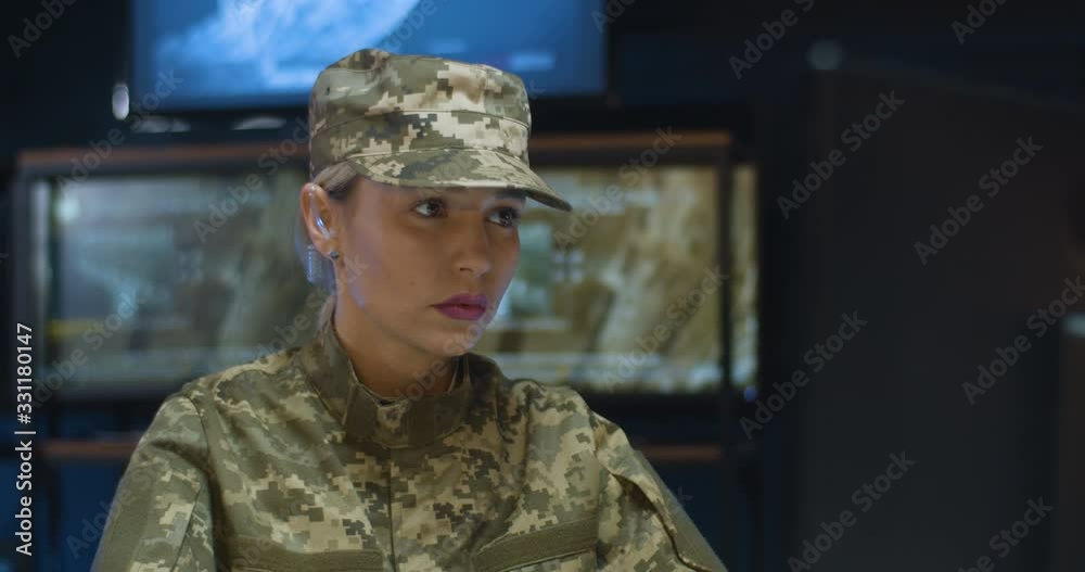 Close up of young pretty woman wearing camouflage clothes sitting at ...
