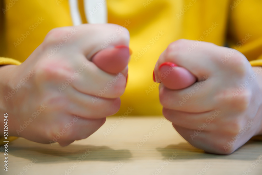 Beautiful female hand with elegant manicure shows a sign of a fig, blue ...