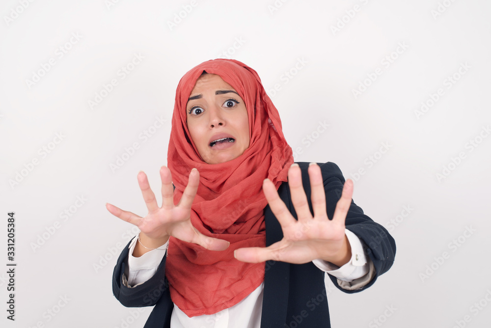 Dissatisfied female model frowns face, has disgusting expression, shows ...