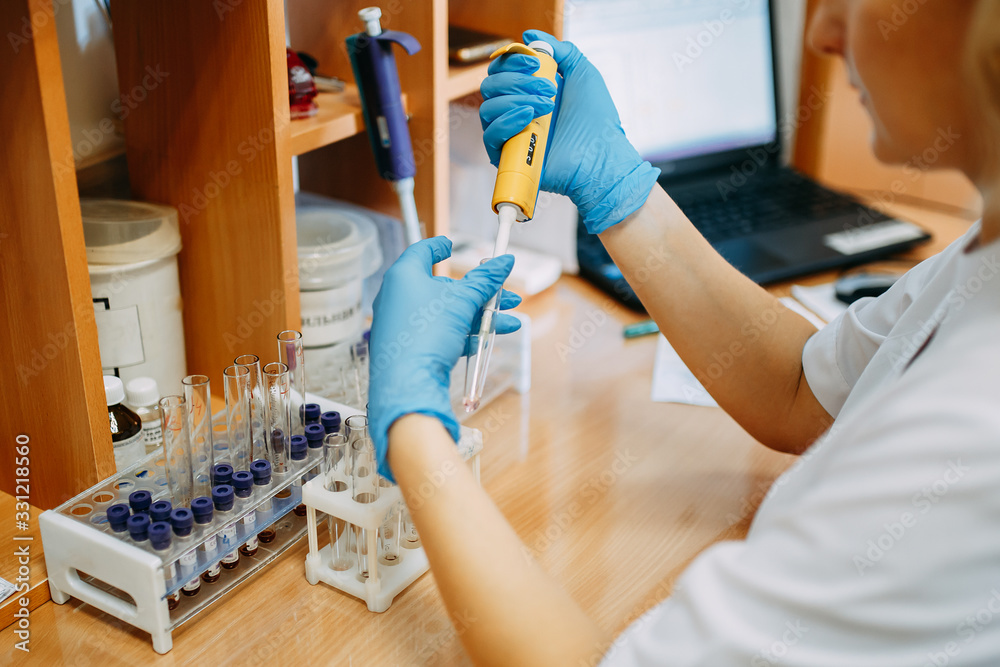 Blood test process in laboratory. Doctor hands making blood test. Many ...