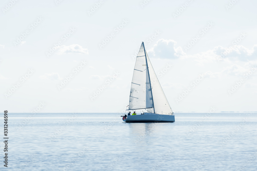 White sloop rigged modern yacht sailing in a Mediterranean sea on a ...