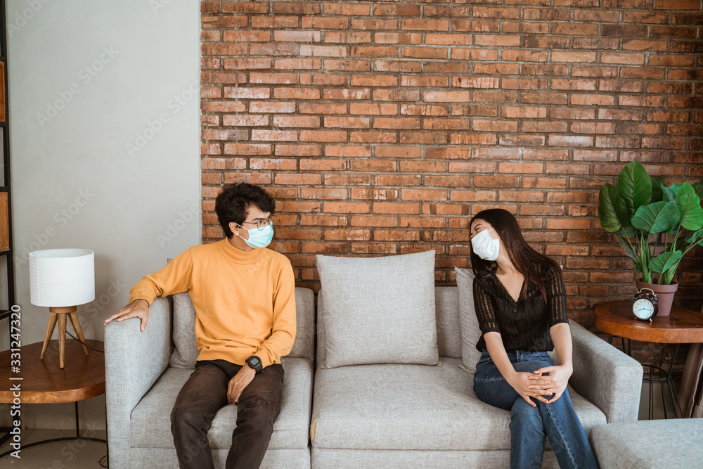 social distancing during virus pandemic. people wearing face masks ...
