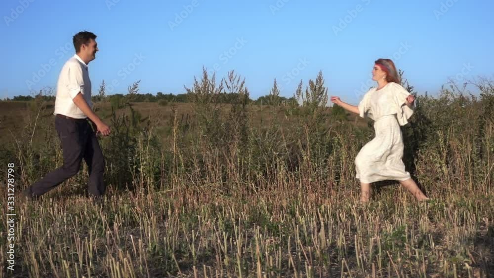 Slow motion of couple in love running to each other then hug and spin ...