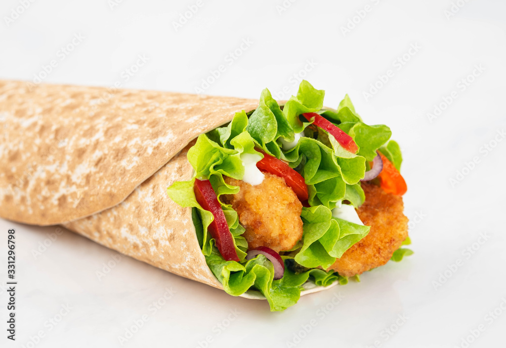 Wrap with fried chicken and vegetables isolated on a white background ...