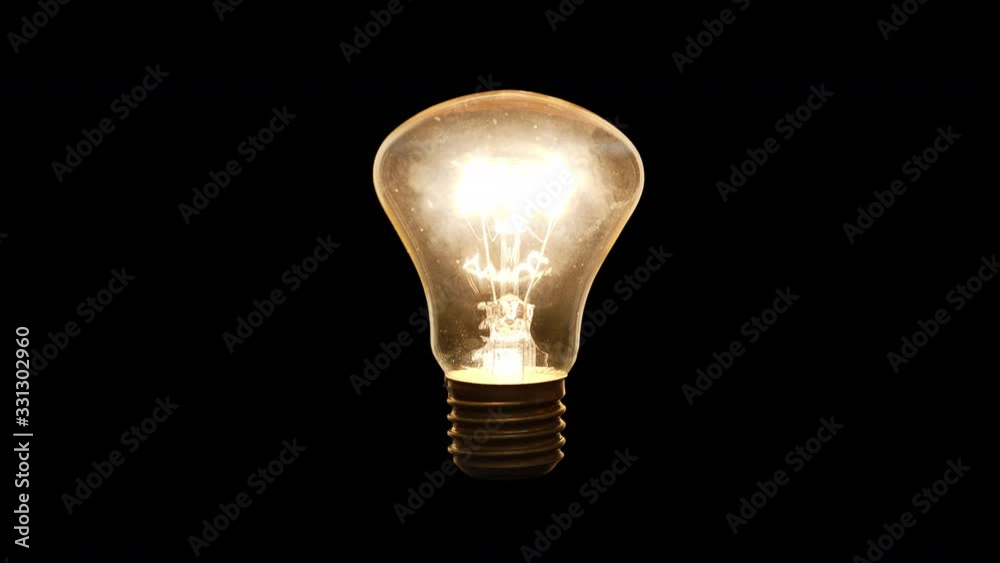 4K - Lights up incandescent light bulb Stock Video | Adobe Stock