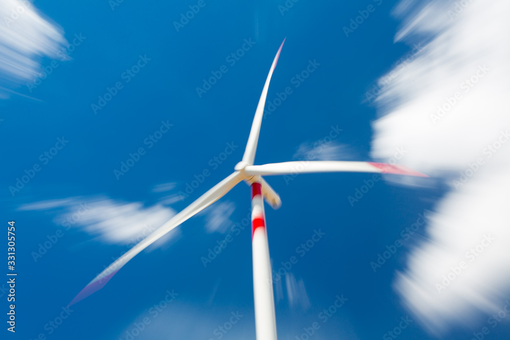 White and red wind turbines on a clear blue sky background in a wind ...