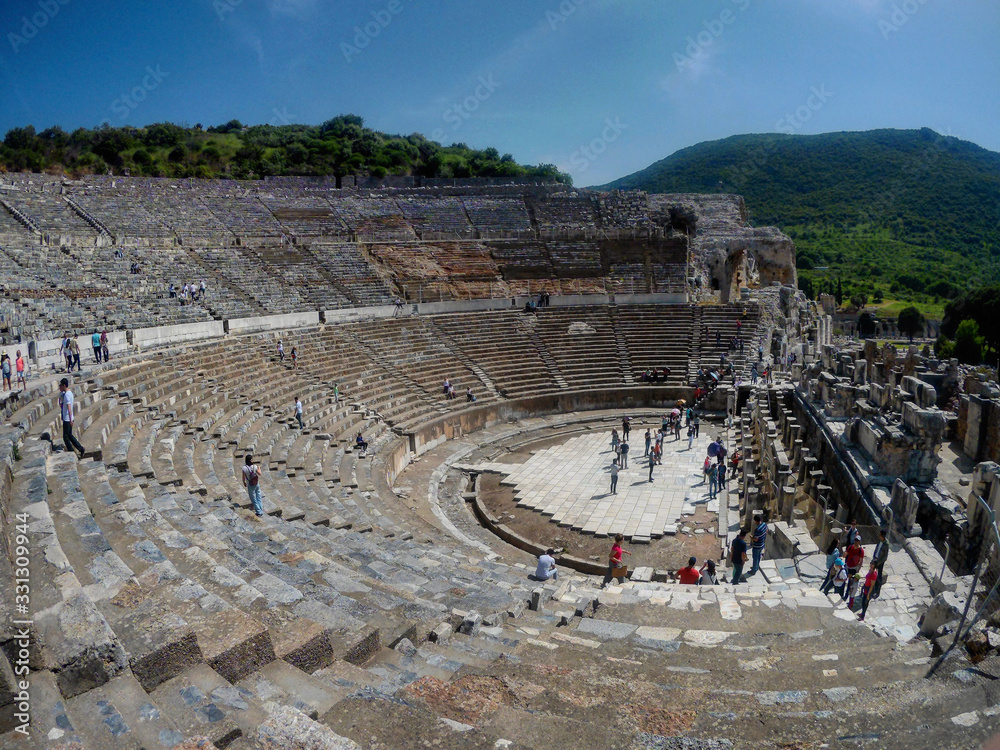 Ancient antique amphitheater. Steps and antique statues with columns in ...