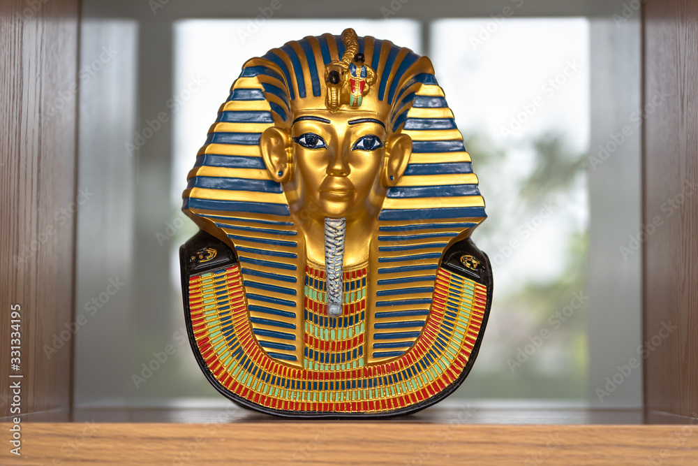 Antique Egyptian gold pharaoh Tutankhamen mask souvenir on wooden ...