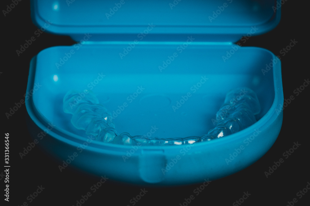 Orthodontic retainer made from transparent plastic in a blue carrying ...