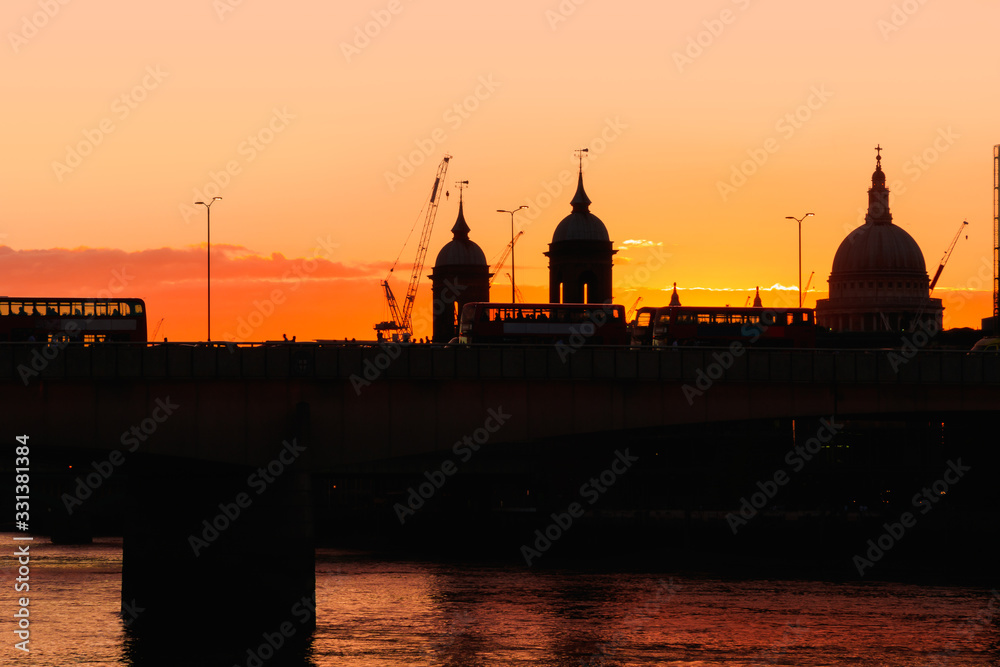 Sunset forming a silhouette of London cityscape including London Bridge ...