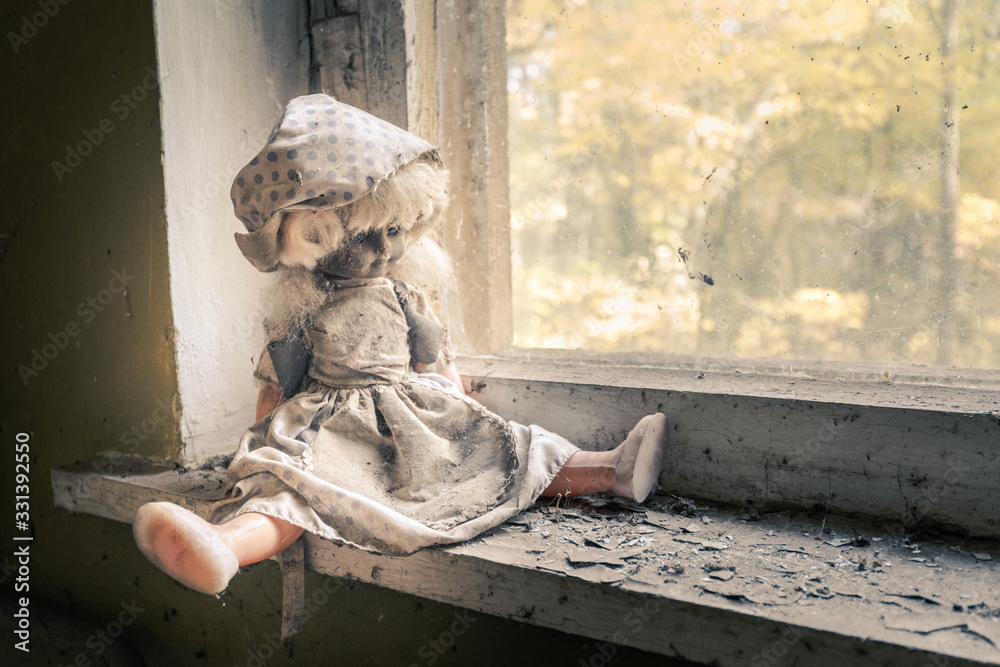 Dusty toy puppet sitting on window board in abandoned kindergarden in ...