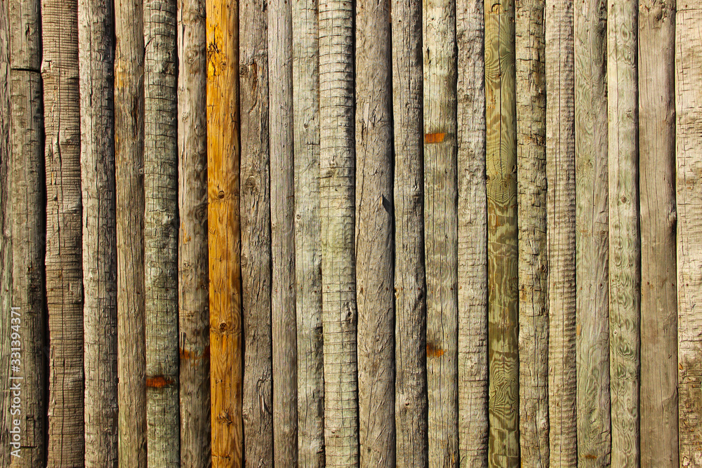 Wall built of different color logs. Old log texture. Vertical wooden ...