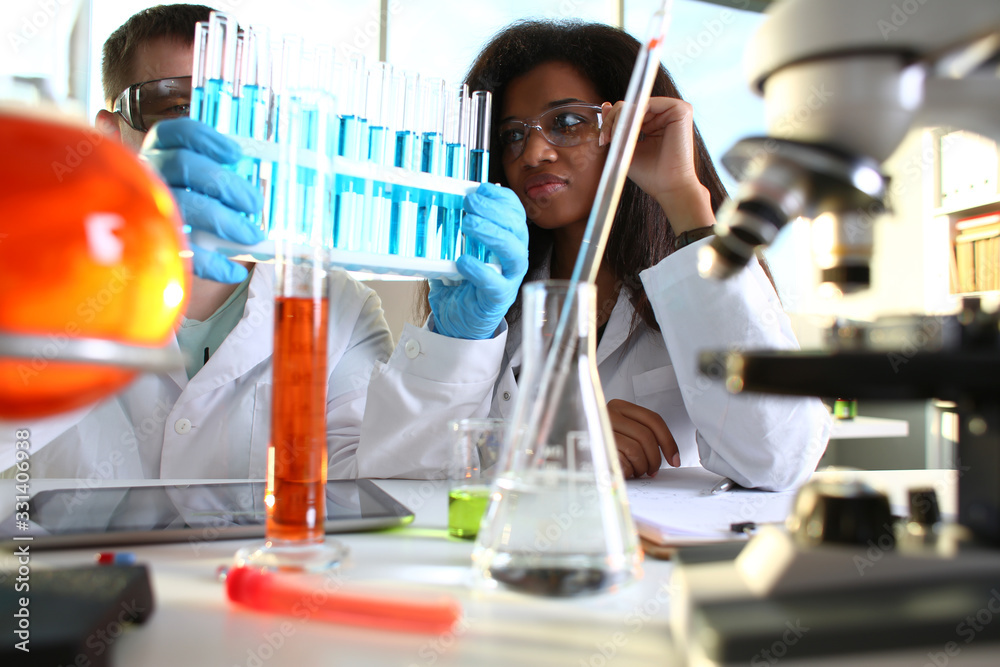 Fotografia do Stock: Male chemist holds test tube of glass in his hand ...