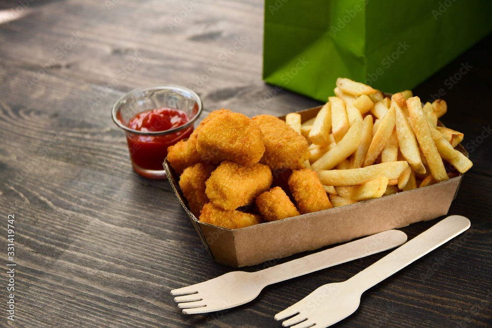 food delivery service. hot chicken nuggets and fries. take out food in ...