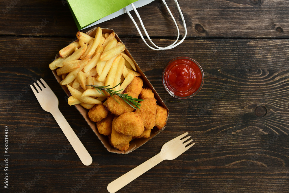 food delivery service. hot chicken nuggets and fries. take out food in ...