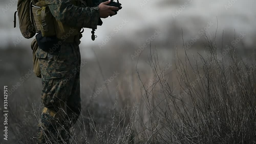 US army soldier holding automatic rifle in defense position during ...