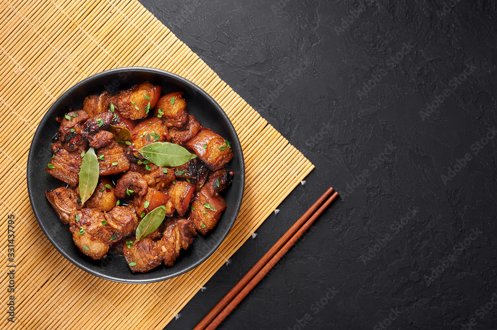 Adobo Pork in black bowl at dark slate background. Pork Adobo or ...
