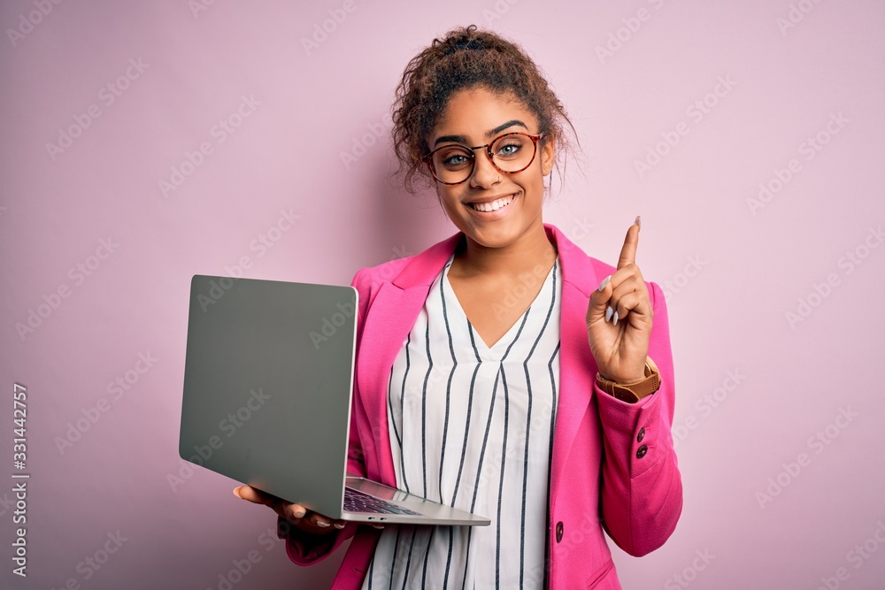 African american business woman wearing glasses working using laptop ...