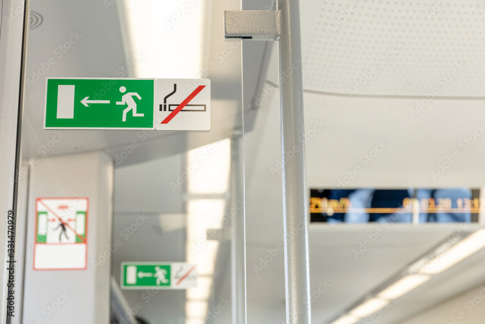 exit sign and no smoking sign in a train car Stock Photo | Adobe Stock