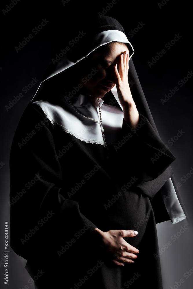 sad crying pregnant nun touching tummy on grey Stock Photo | Adobe Stock