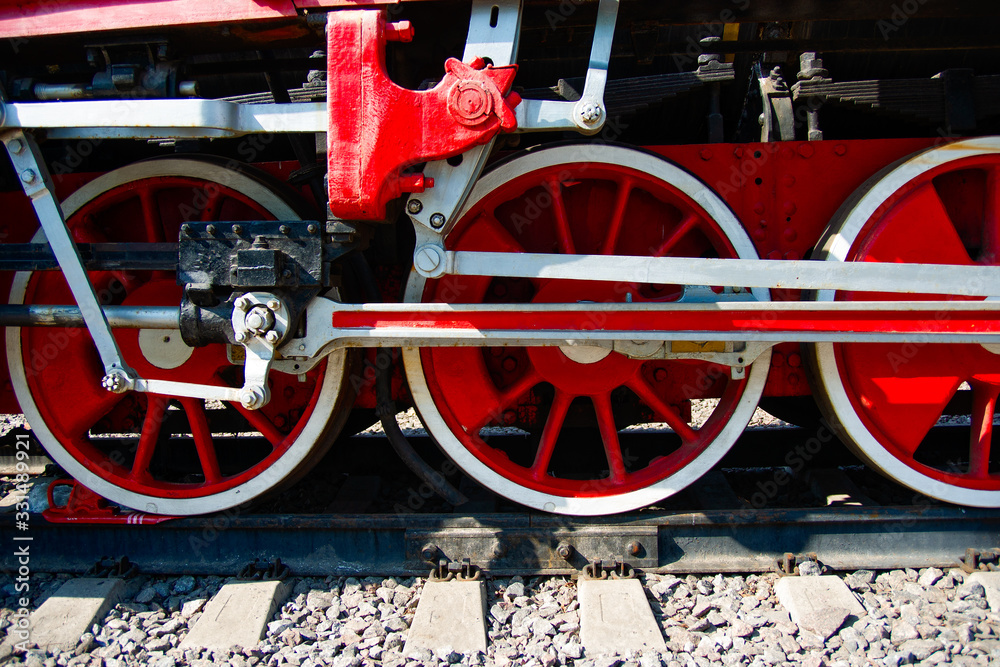 Red driving wheels of a vintage steam engine locomotive. Driving rods ...