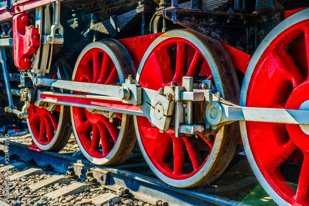 Red driving wheels of a vintage steam engine locomotive. Driving rods ...