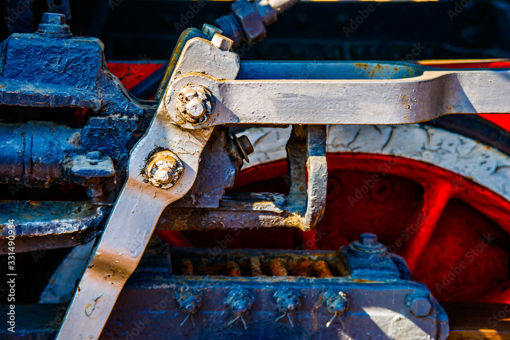 Metal parts and details of driving wheels of a vintage steam engine ...