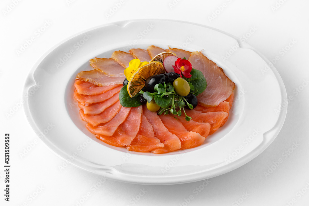 Plate with appetizer of fish and seafood. Sliced salted fish fillet ...