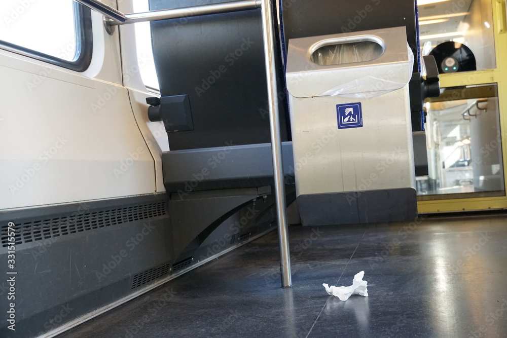 a used paper tissue out of waste bin or dust bin in a commuter train ...