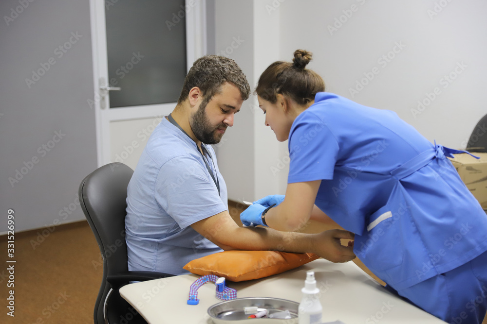 Doctor Injecting patient in arm With Syringe To Collect Blood. Nurse ...