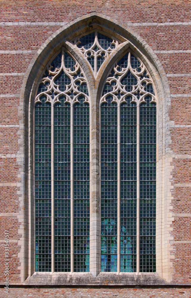 Pointed ogive arch with gothic window at the brick facade of ...