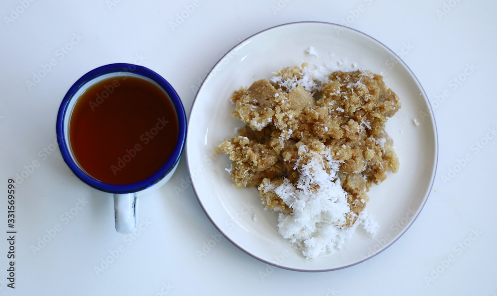 Tiwul and a cup of tea on white background. Tiwul is Indonesian ...