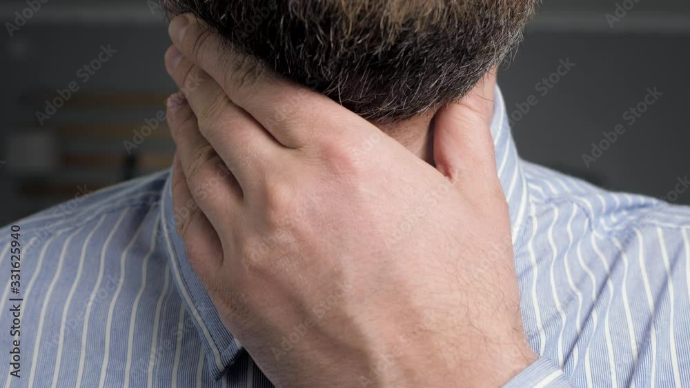 Man touches her throat her hand and swallows. Sore throat, tonsillitis ...
