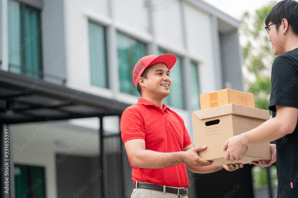 Customer pick-up parcel cardboard box package from red delivery man ...