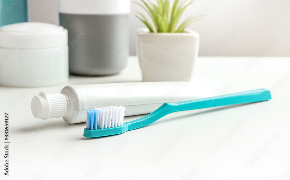 Plastic toothbrush and toothpaste in bathroom on grey background Stock ...
