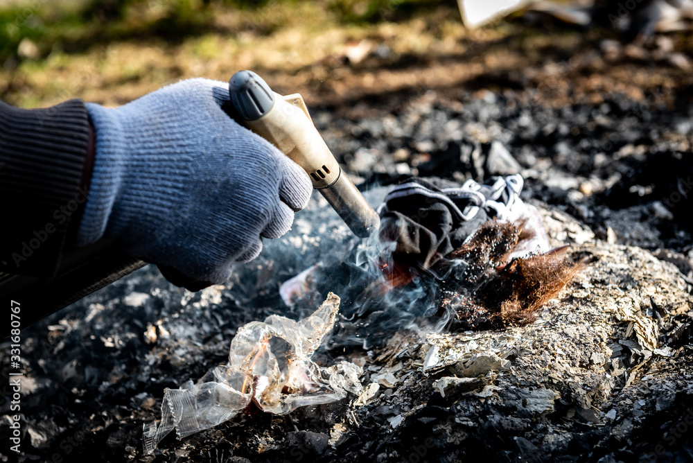 Lighting a fire with a gas can. Lighter with pistol with gas cartridge ...