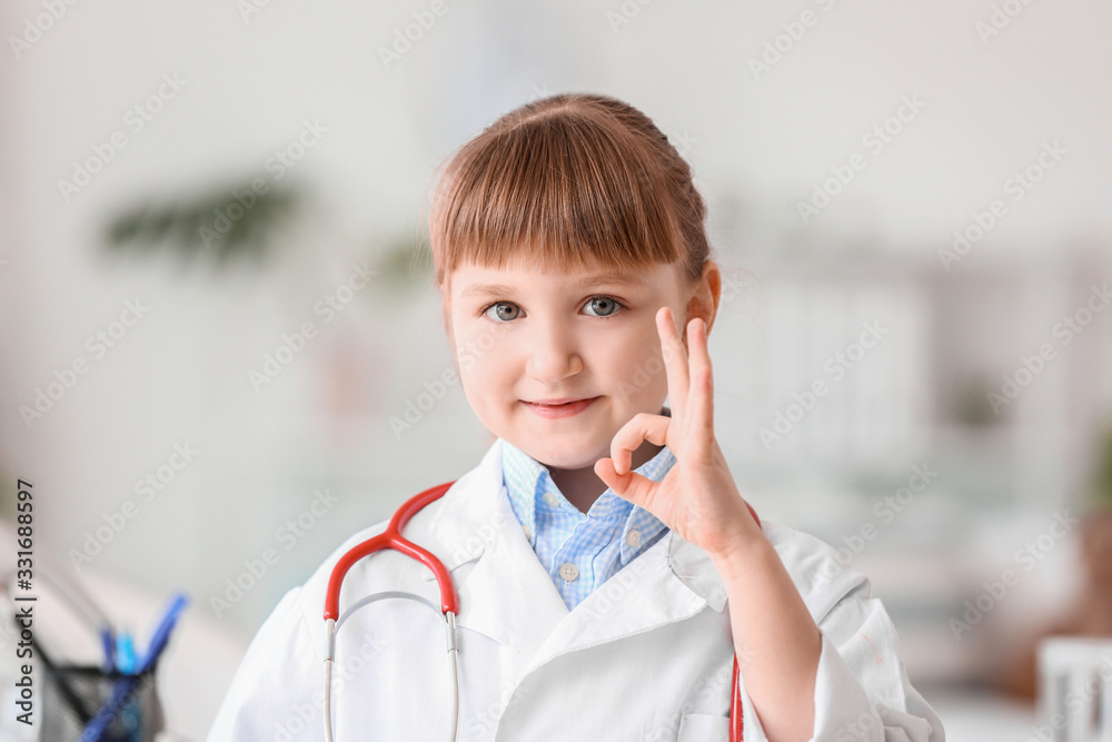 Cute little doctor showing OK gesture in clinic Stock Photo | Adobe Stock