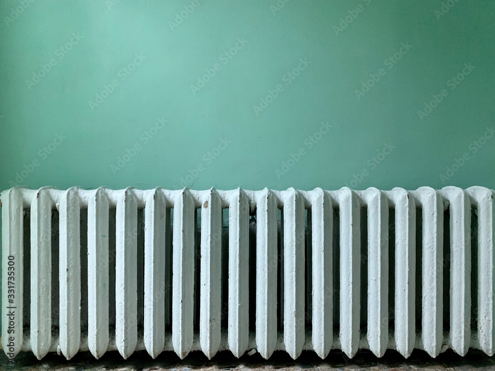 Cast iron batteries in a public building. Old heating radiators on the ...