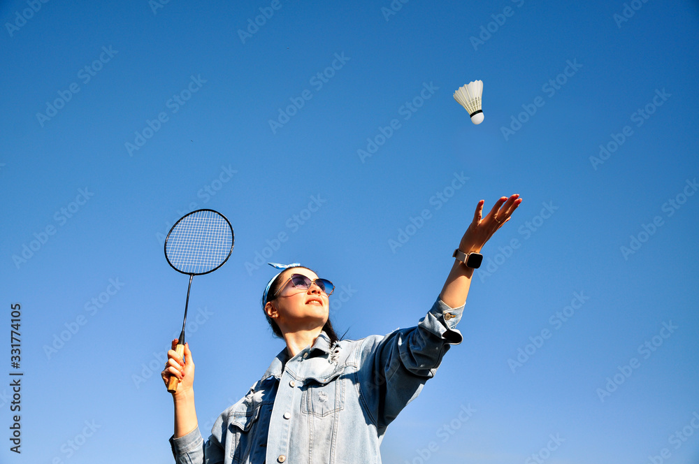 young girl playing badminton Stock Photo | Adobe Stock