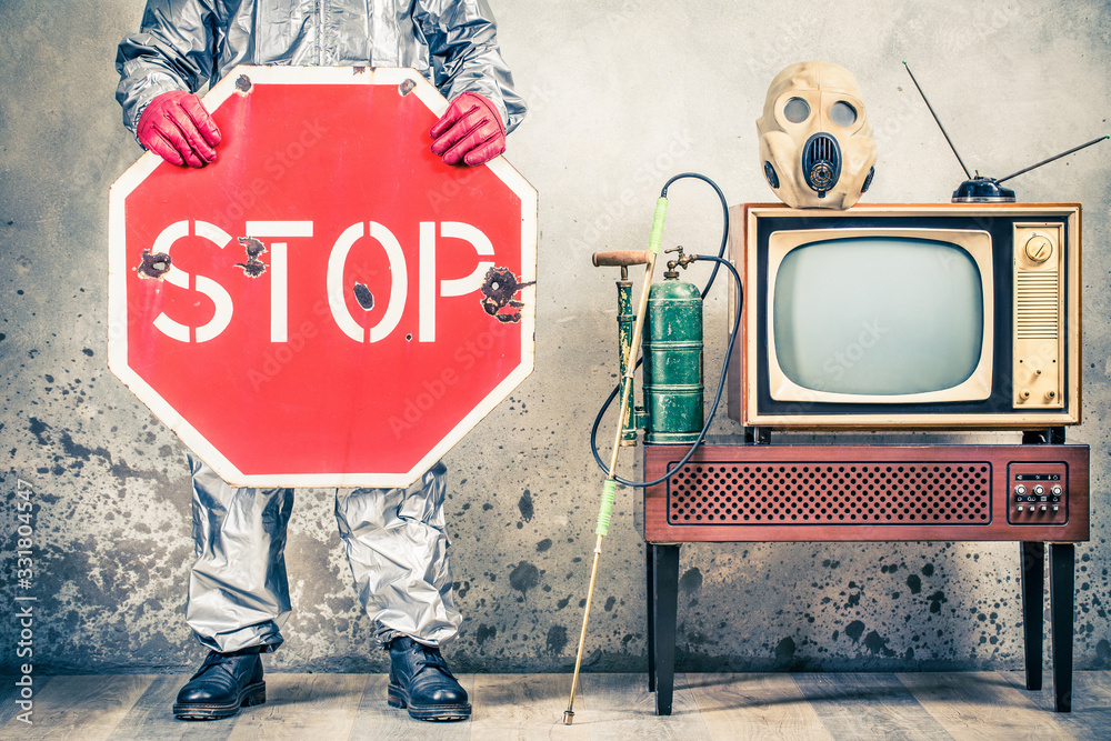 Human in protective uniform, gloves with STOP sign, TV, vintage ...