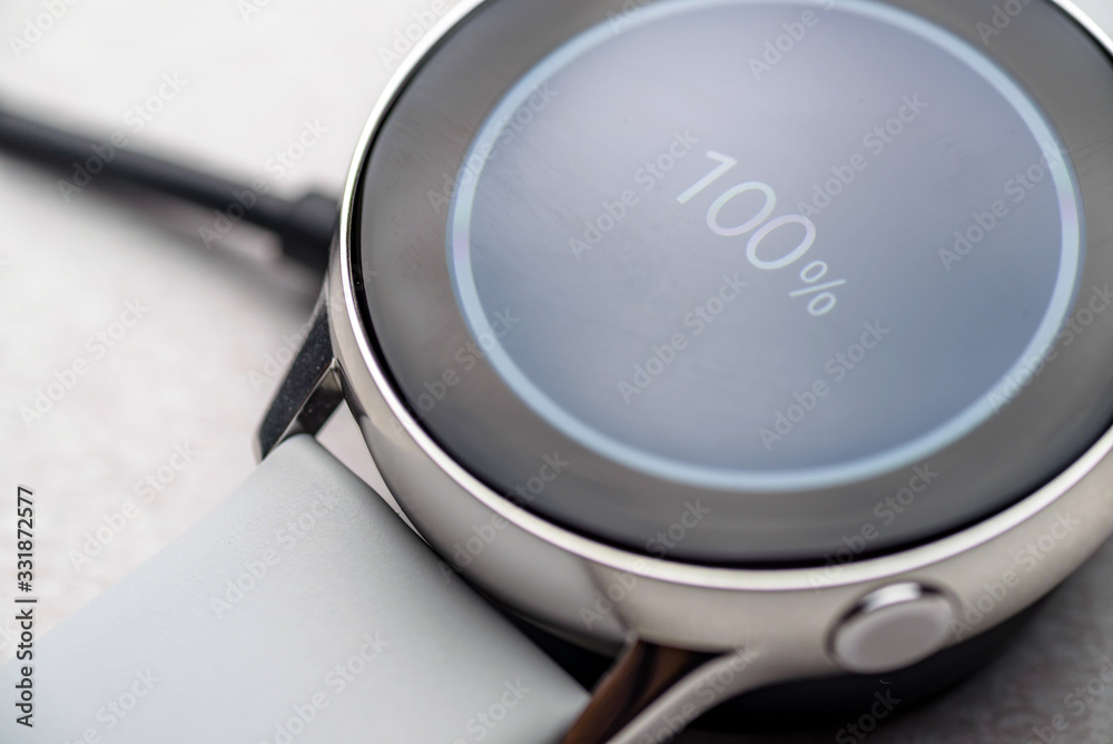 smart watch wireless charging on charging pad on kitchen worktop table ...