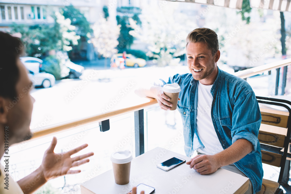 Casual guys having coffee in street cafe and talking Stock Photo ...