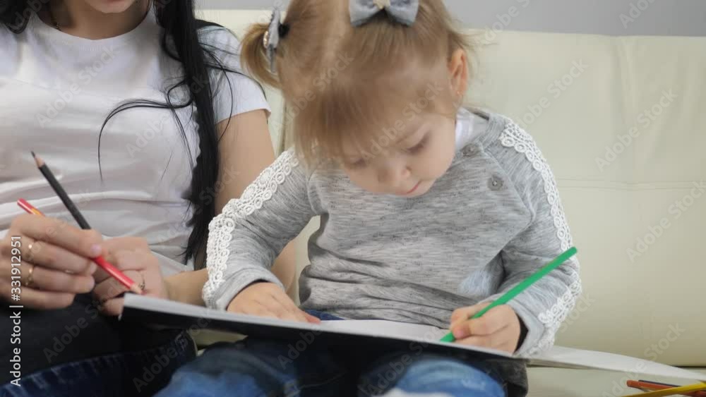 little girl and mom draw teamwork happy family concept. child daughter ...