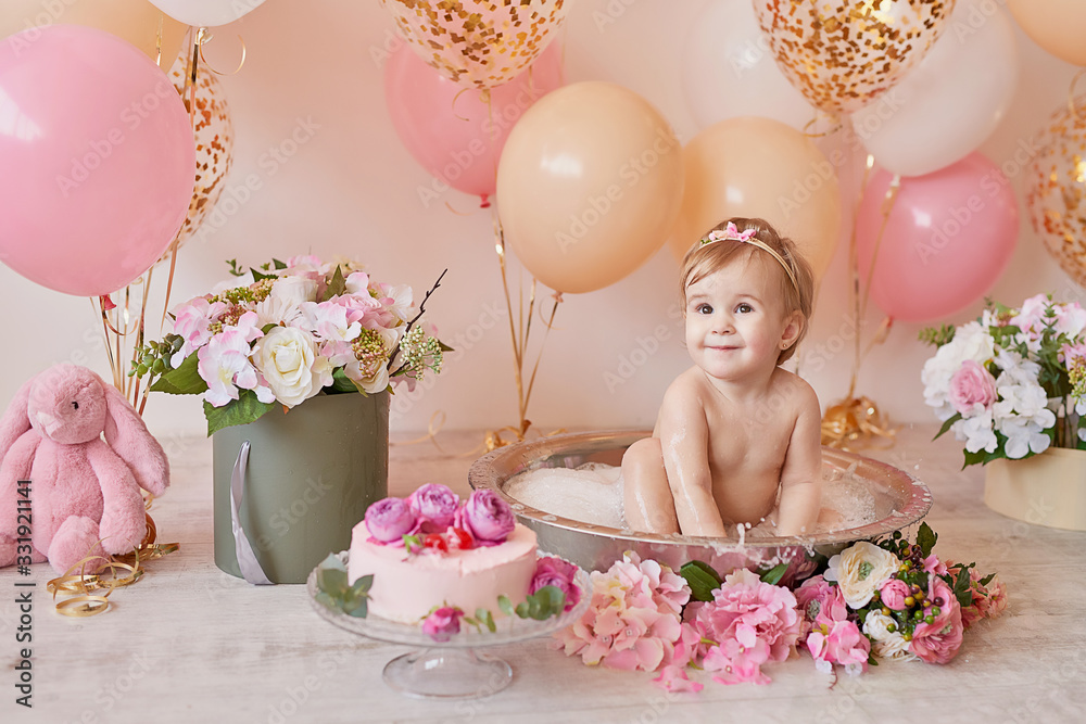 Smash cake party. Little cheerful birthday girl with first cake. Happy ...